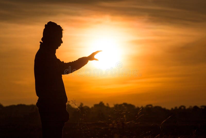 Silhouette of a Man Standing and Rise His Hands Up in the Air Du Stock ...