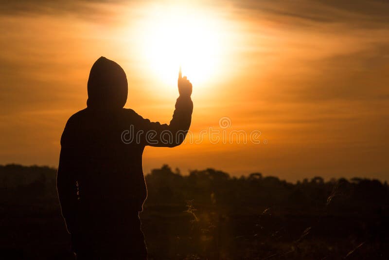 Silhouette of a Man Standing and Rise His Hands Up in the Air Du Stock ...