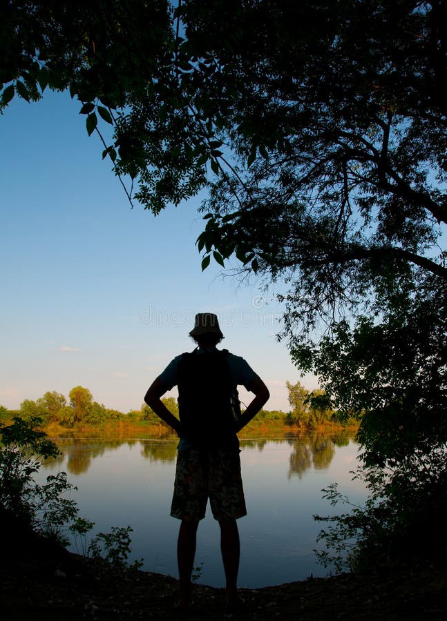 Silhouette of the Man Standing on the River Shore Stock Image - Image ...