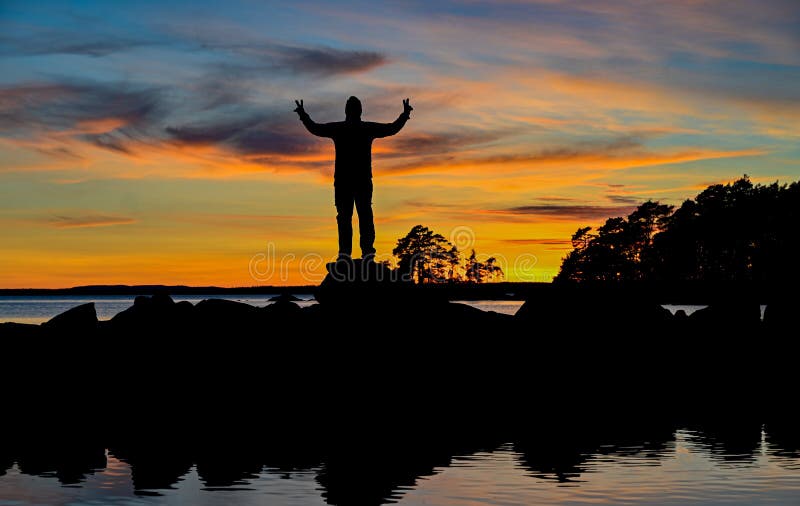 Silhouette of Man Standing Strong Infront of Sunset and Lake Stock ...