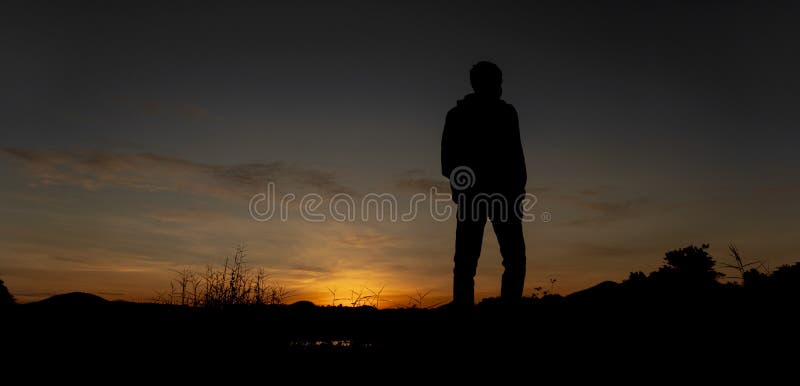 Silhouette of a Man Standing at Sunset Stock Image - Image of horizon ...