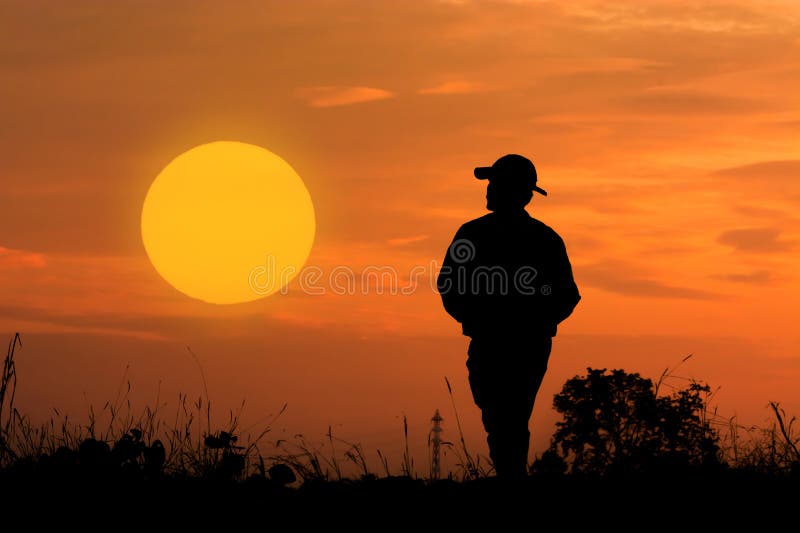 Silhouette of Man Standing at Sunset in Nature. Big Round Sun in ...