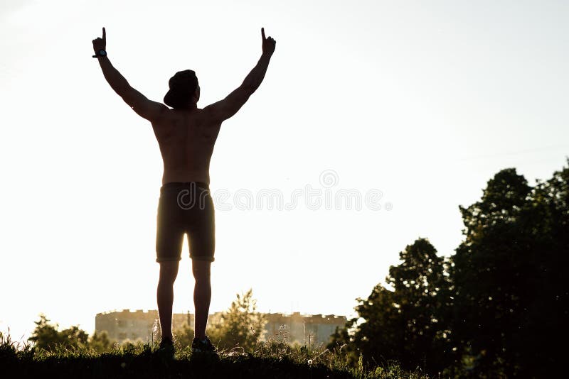 Silhouette of a Man at Sunset, Hands Raised, Victory, Joy Stock Photo ...