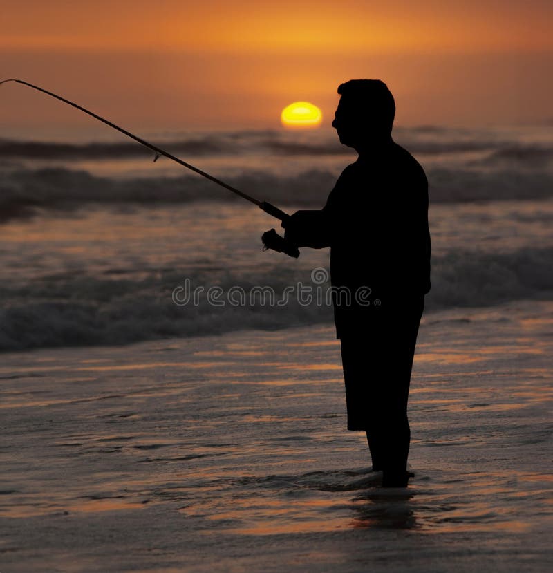 Silhouette of a Man Surf Fishing at Sunset with the Sun Visible Stock ...