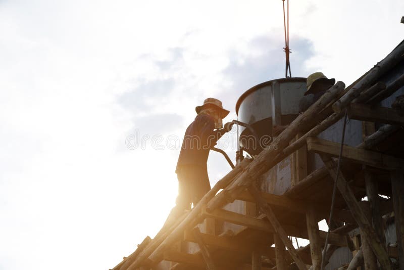 Silhouette of Manpower with Excavator Loading Cement into Construction ...