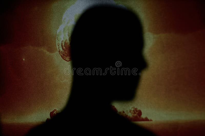 Silhouette of Mans Head Against Projection of Nuclear Bomb Explosion in ...
