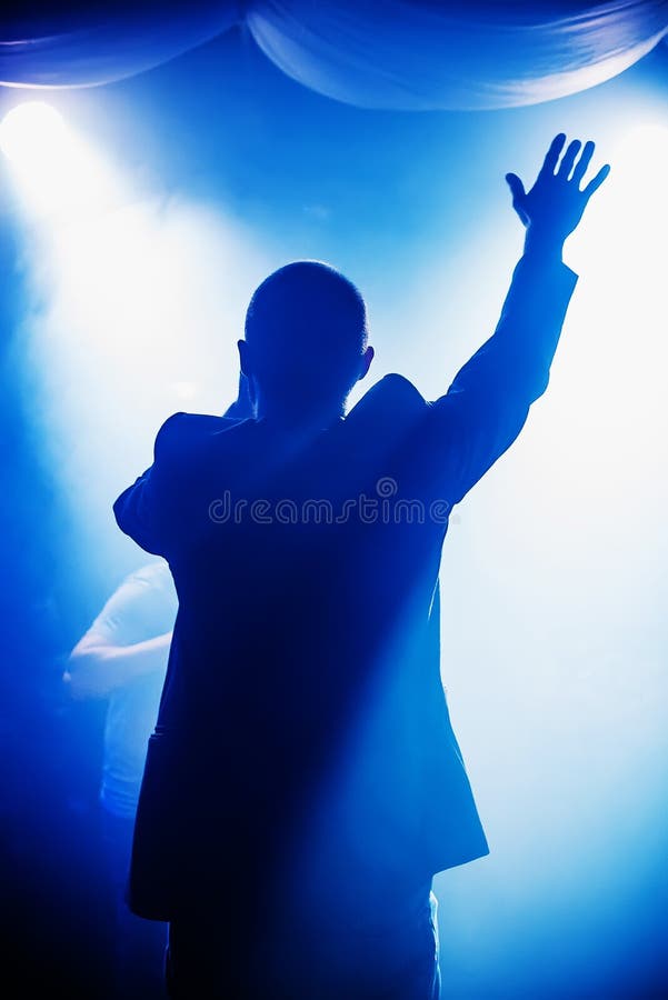 Silhouette of the MC with a Microphone on Stage of Nightclub Stock ...