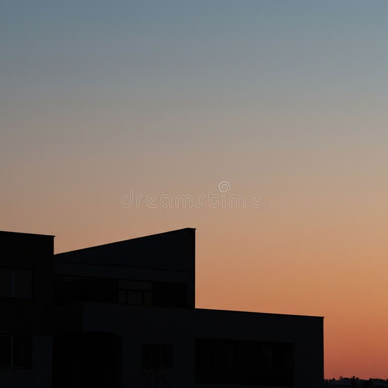 Silhouette of a Modern Building with Angular Rooftops Against a Sunset ...