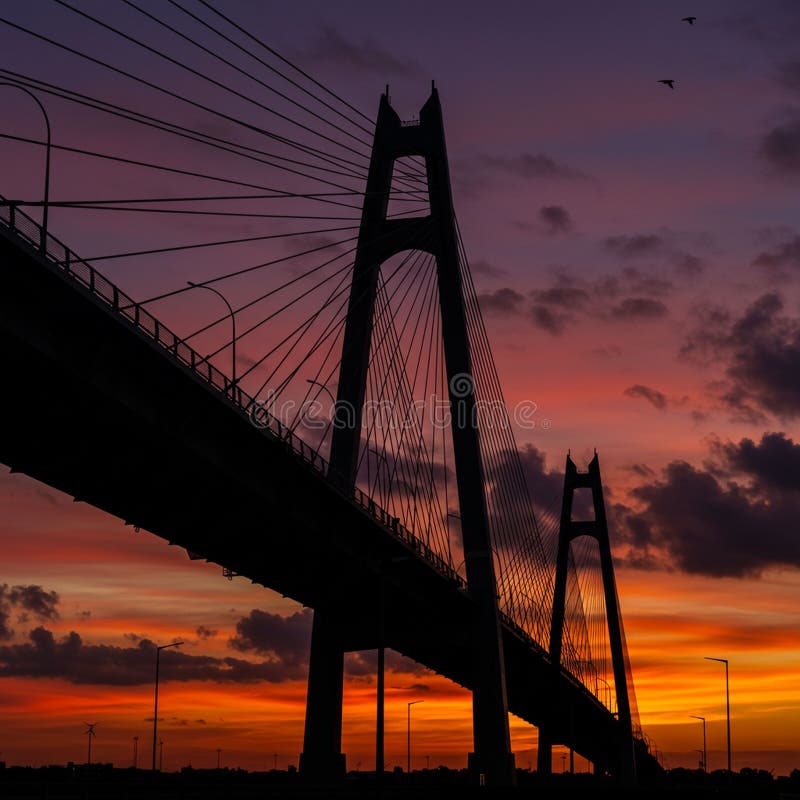 Silhouette of a Modern Cable-stayed Bridge at Sunset, Contrasting ...