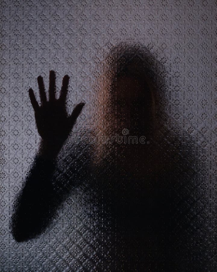 Silhouette Of A Mysterious Woman Standing Behind Frosted Glass Stock Image Image Of Violence