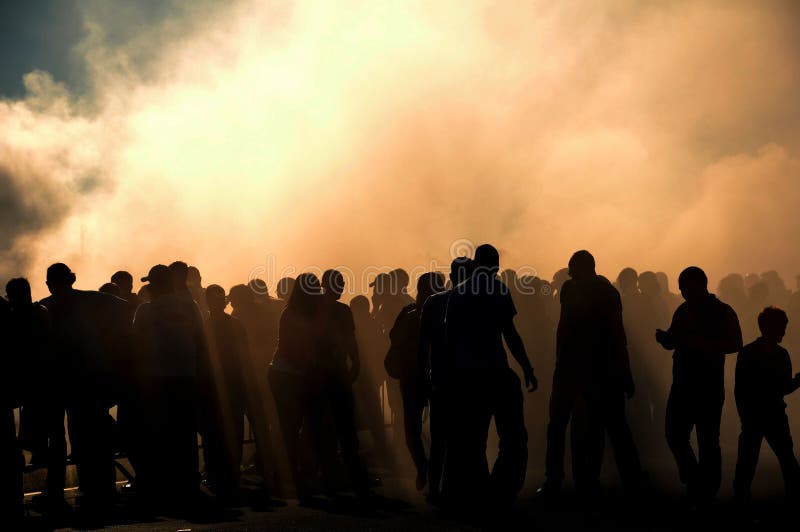 Silhouette of a People in the Crowd with Smoke at Sunset Stock Image ...