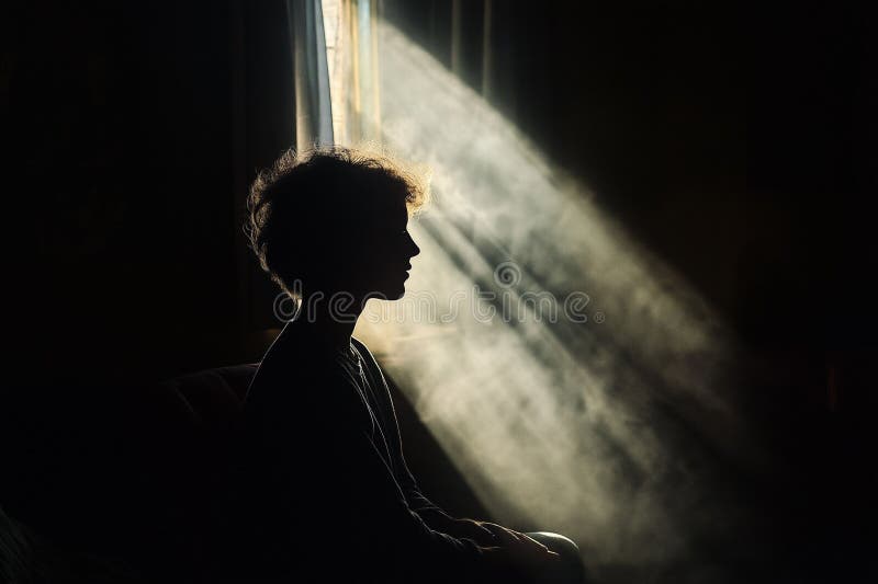 Silhouette of a Person with Light Rays Streaming through a Window ...