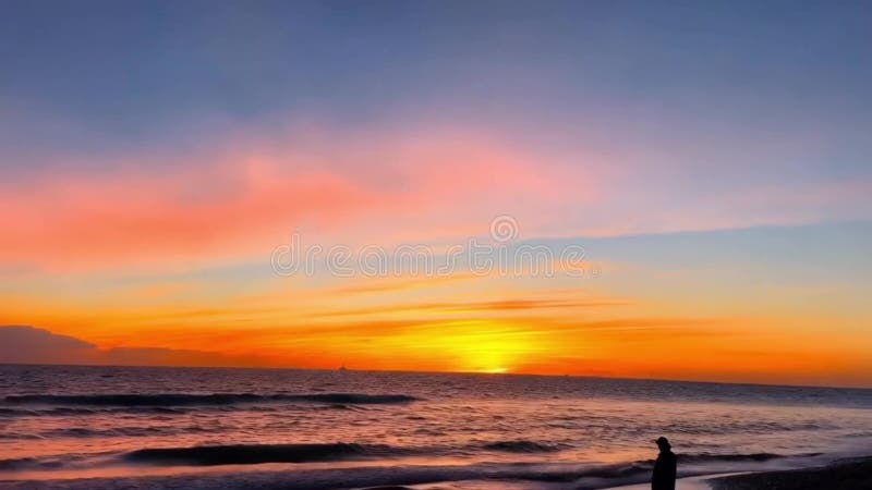 Silhouette of a Person at Sunset on a Tranquil Beach Stock Video ...