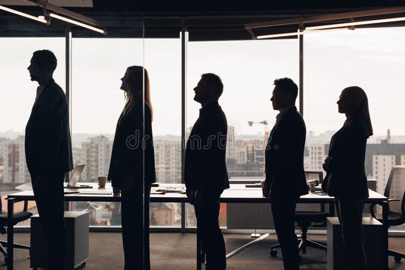 Silhouette Photo of a Group of Businessmen Standing Side by Side in ...