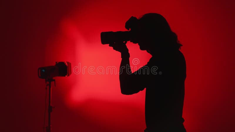 Silhouette of Photographer in Dramatic Red Light Scene Stock Footage ...