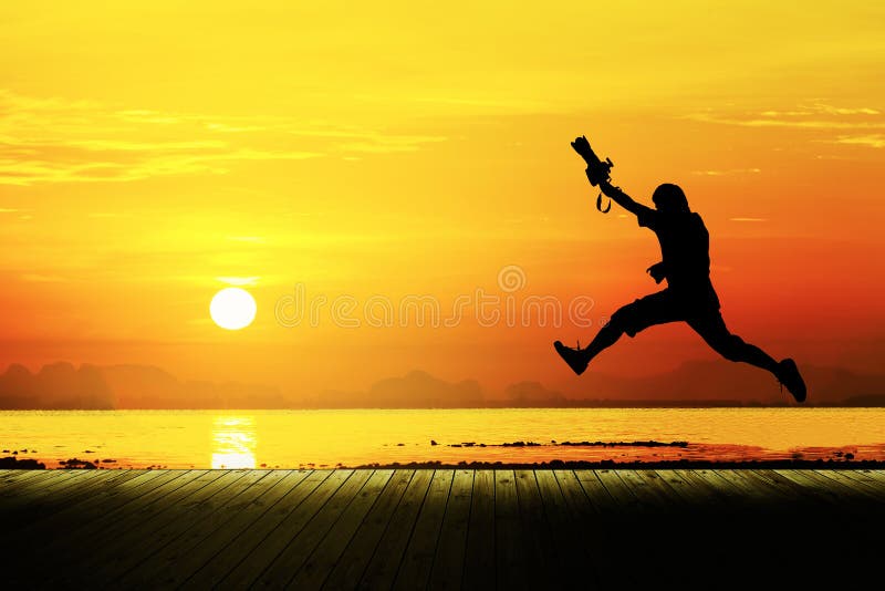 Silhouette of Photographer Jumping with Sunset, Seascape. Stock Photo ...