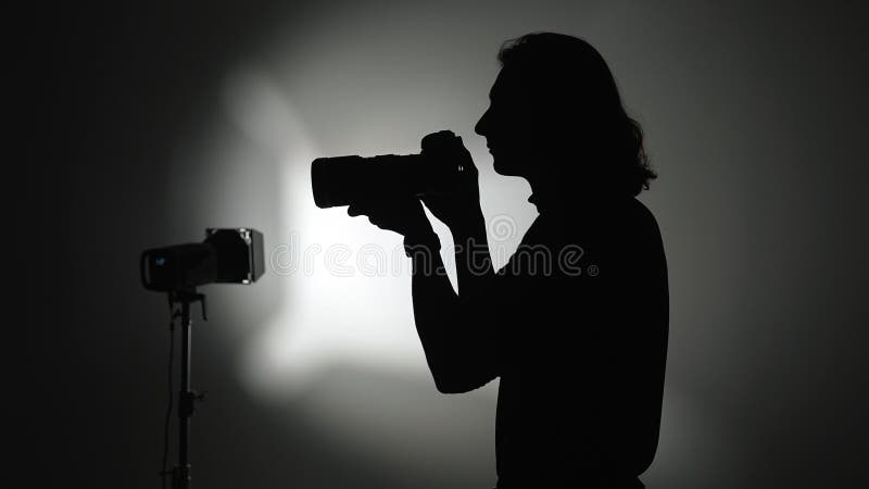 Silhouette of Photographer in Studio with Professional Camera Stock ...