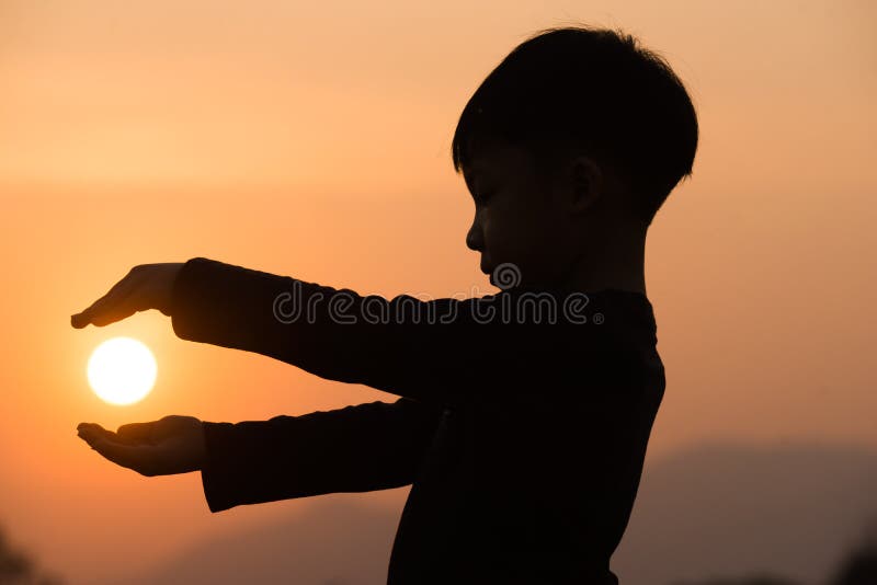 A Boy Playing with the Sun at Sun Set. Stock Photo - Image of shadow ...