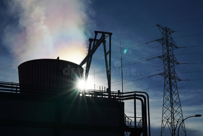 Silhouette of a Power Plant with Steam Coming from the Stack Against a ...