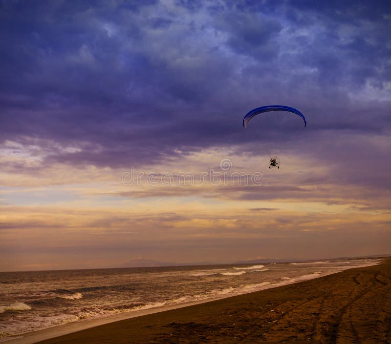 The Silhouette of Powered Paraglider Soaring Flight Over the Sea ...