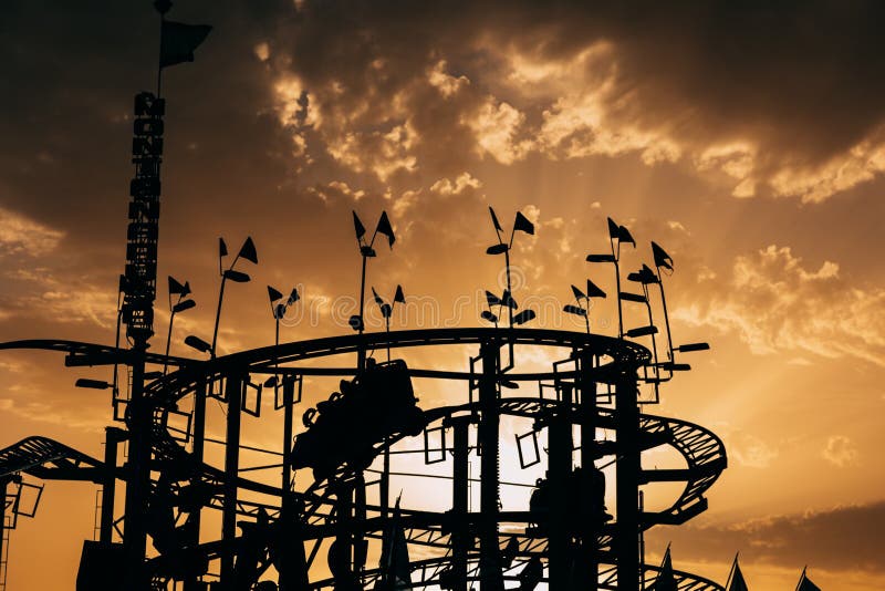 Silhouette of a Roller Coaster in an Amusement Park during Sunset ...