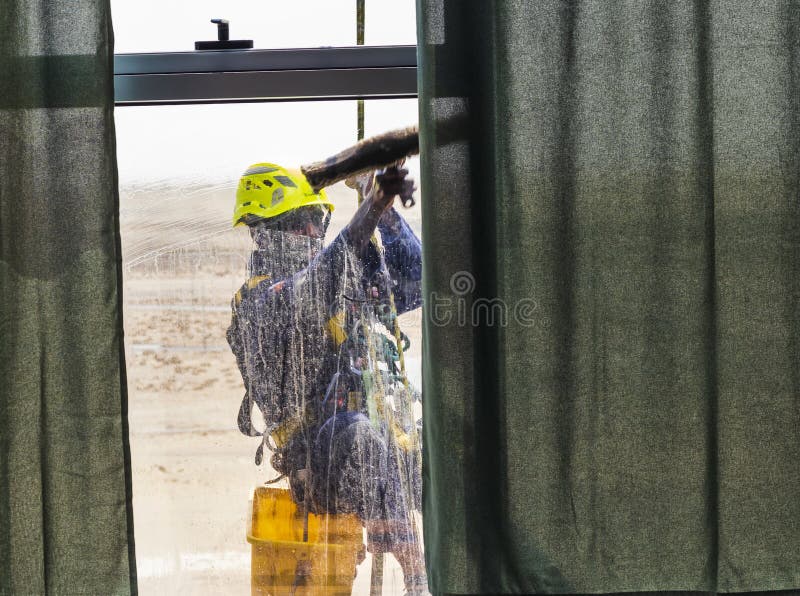 Silhouette of a Rope Access Glass Cleaner Working at Heights ...