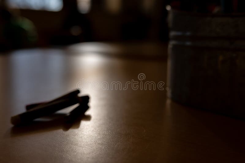 Silhouette of Several Crayons and Markers on a Table with Light ...