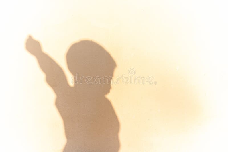 Details of a Silhouette Shadow of an Asian Boy on a White Concrete Wall ...