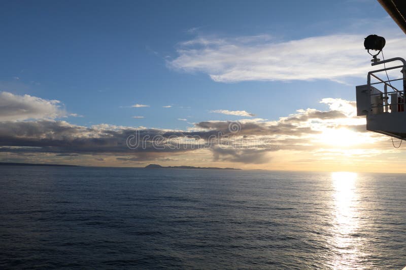 Silhouette of a Ships Bridge Wing with the Sun Setting in a Calm Ocean ...