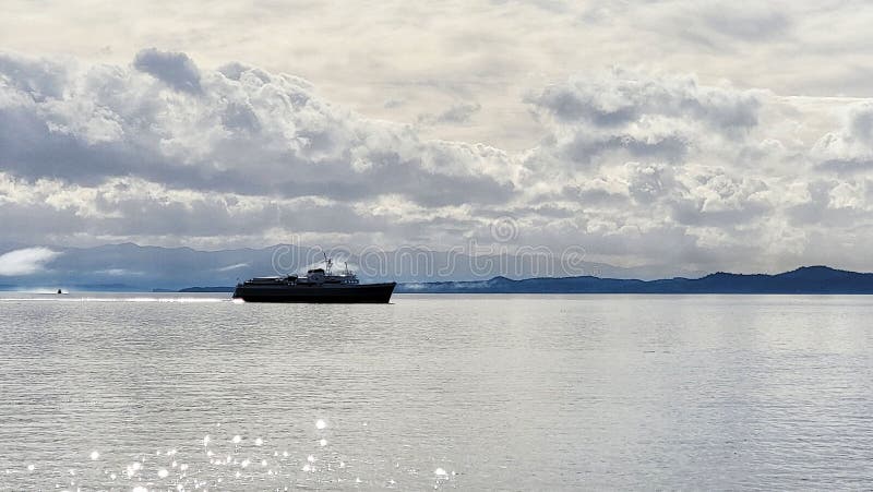 Silhouette Shot of a Ship Sailing through Calm Open Water with the ...