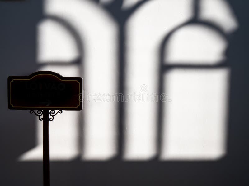 Silhouette of the Sign with the Stand on the Left Behind the Shadow of ...