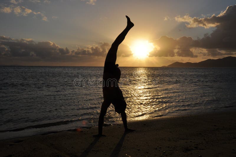 Silhouette Doing Handstand on Beach at Sunset Stock Image - Image of ...