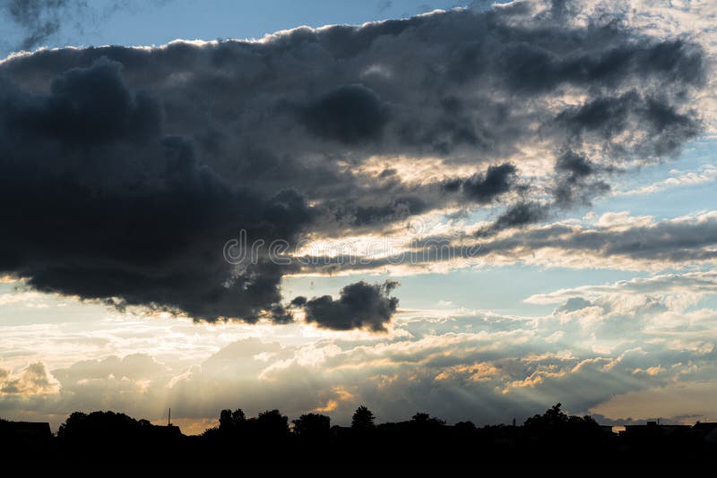 Silhouette of Suburban Scenery Under Dramatic Backlit Clouds. Stock ...