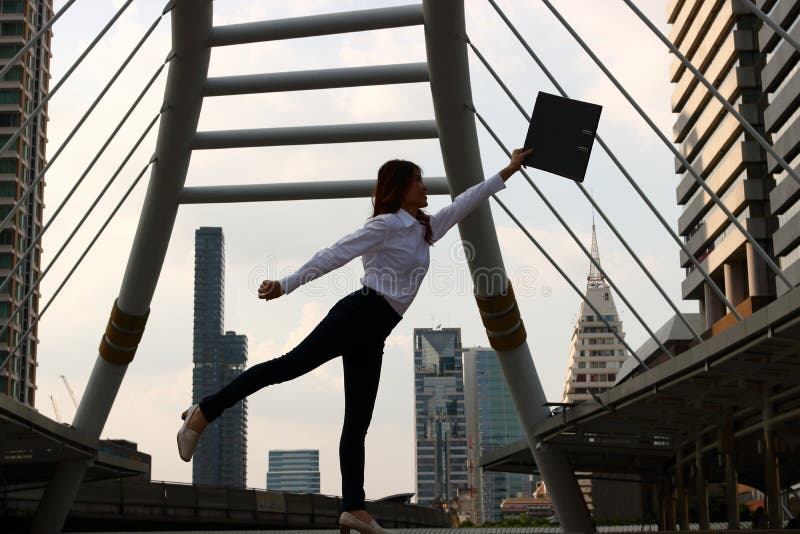 Back View of Successful Young Aian Business Woman Raising Her Hands at ... Back View of Successful Young Aian Business Woman Raising Her Hands at ...