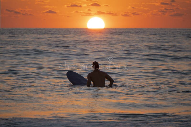 Silhouette of Surfer Waiting on the Line Up for a Wave at Sunrise or ...