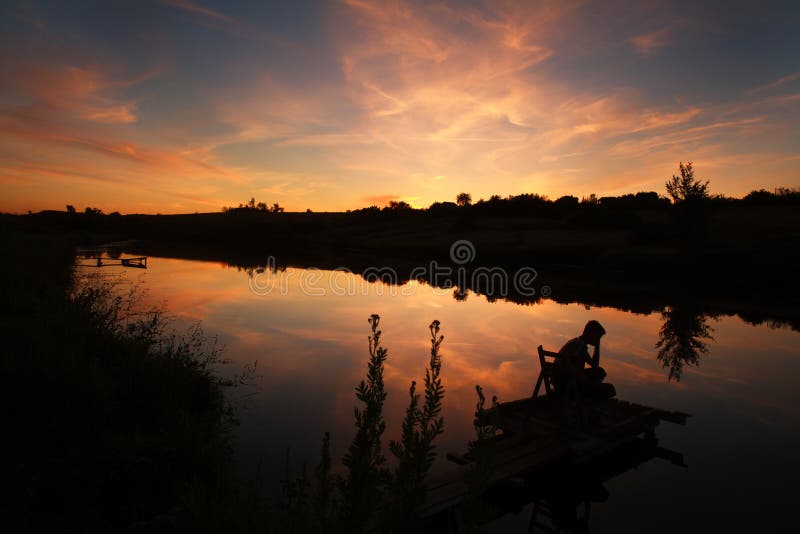 Silhouette of Thoughtful Man on River Dramatic Sunset Sky Stock Photo ...