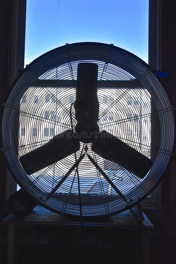 Three Bladed Fan Silhouetted in a Window Frame Stock Photo - Image of ...