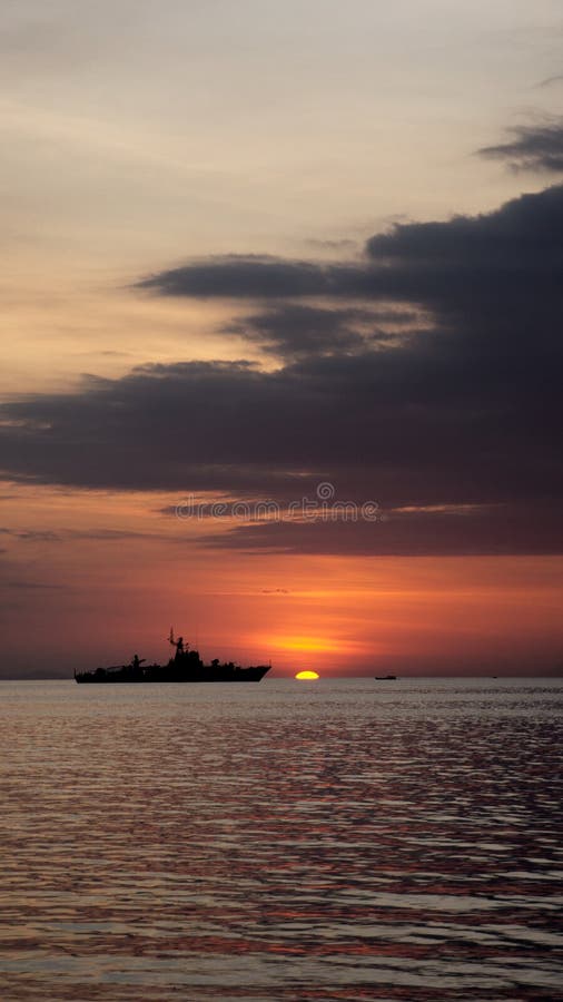 Silhouette of Big Ship on the Ocean at Nightfall with Orange Sunset ...