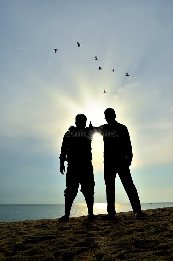 Silhouette of Two Friends Sitting on Wood Bench Near Beach Stock Photo ...