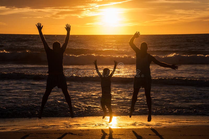 Silhouette of Two Men and a Boy Having Fun in the Sunset Stock Photo ...