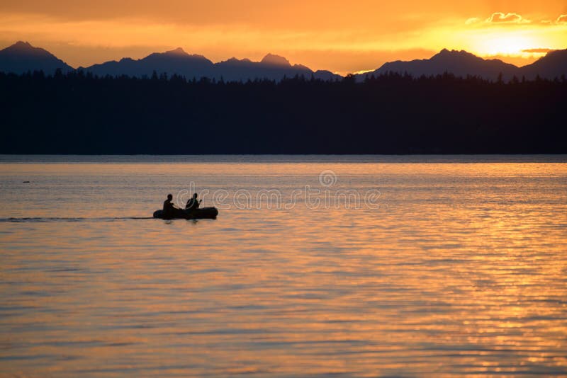 Silhouette of Two Men Rowing in a Boat at Sunset Stock Photo - Image of ...