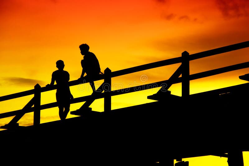 Silhouette of Two People on the Bridge at Dusk. Stock Image - Image of ...