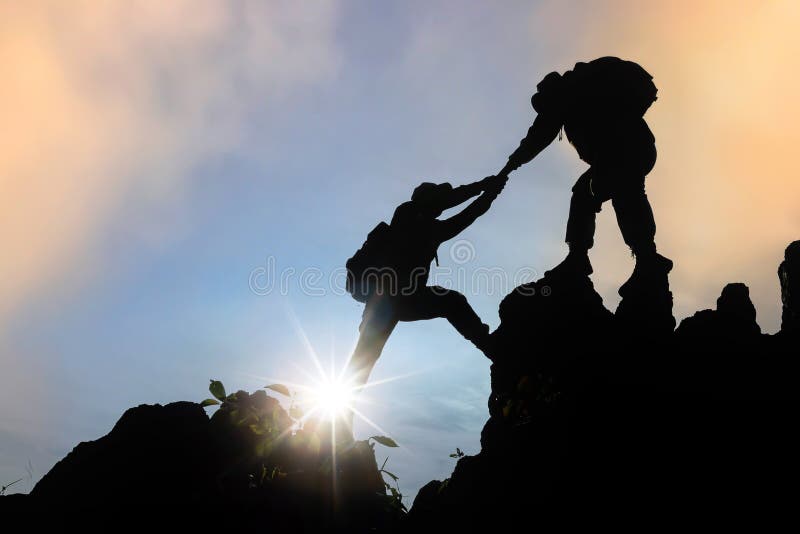Silhouette of Two People Climbing a Mountain in a Trekking Activity at ...