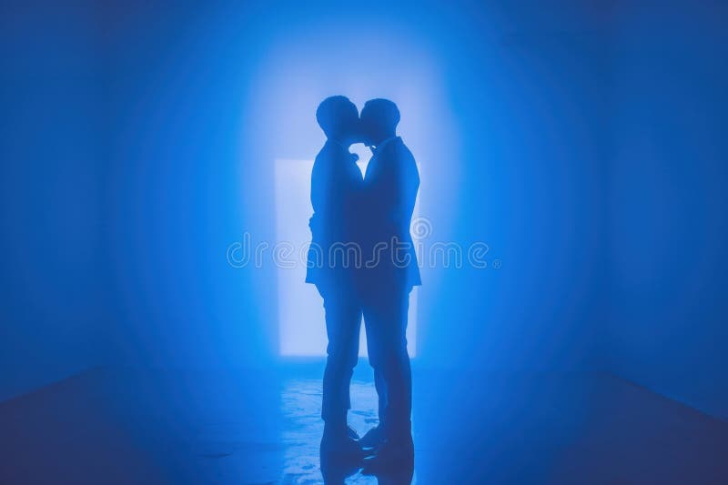 Silhouette of Two People Embracing in Blue Light Stock Image - Image of ...