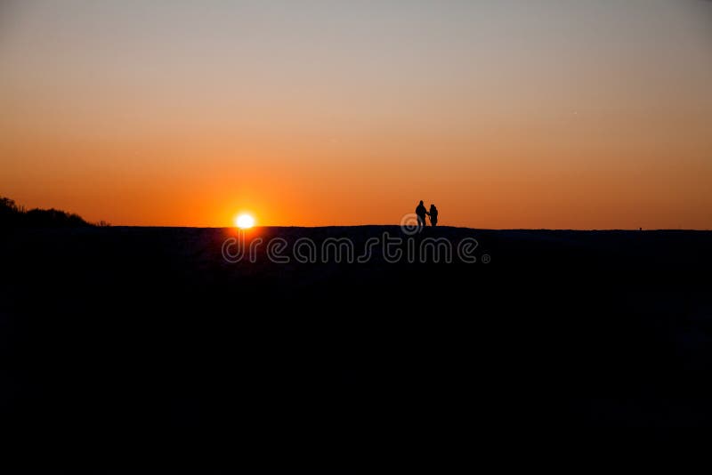 Silhouette of Two People at Sunset Stock Photo - Image of freedom ...