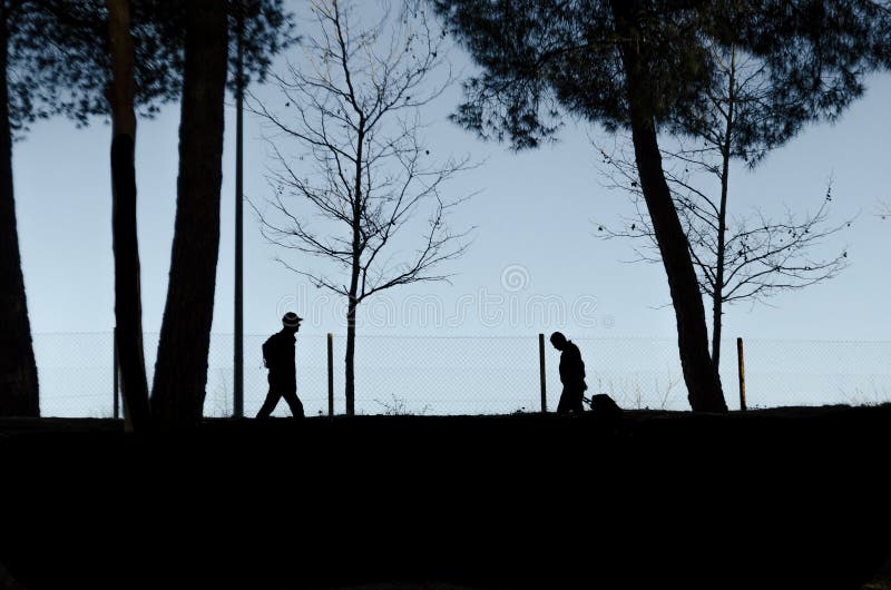 Silhouette of Two People Walking Opposite Each Other To Meet Stock ...