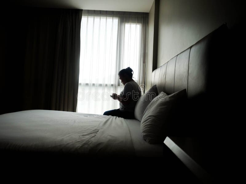 Silhouette of Upset Woman Sitting Using the Phone in Bed, Lonely, Alone ...
