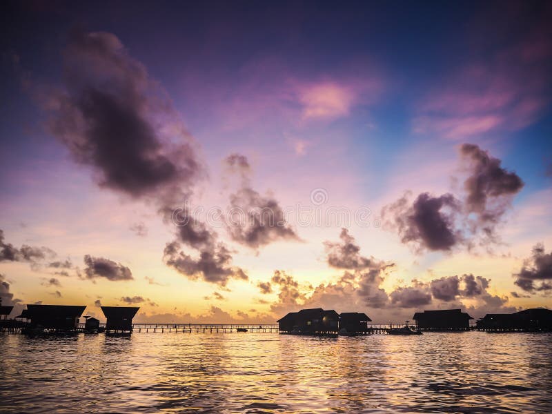 Silhouette of Water Villa Cottages at Sunrise or Sunset Stock Image ...