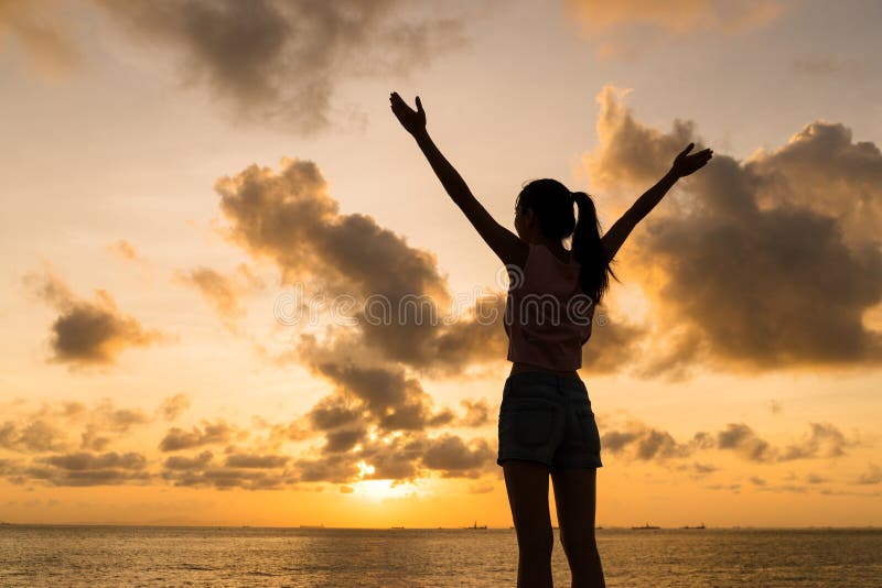 Silhouette of Woman Open Arm Under Skyline in the Evening Stock Photo ...