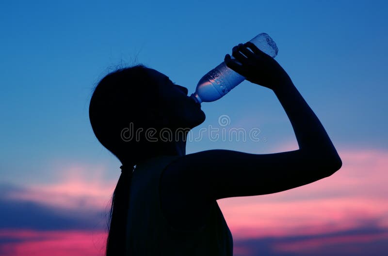 Silhouette of Woman Rehydrate and Refresh at Sunset Stock Photo - Image ...